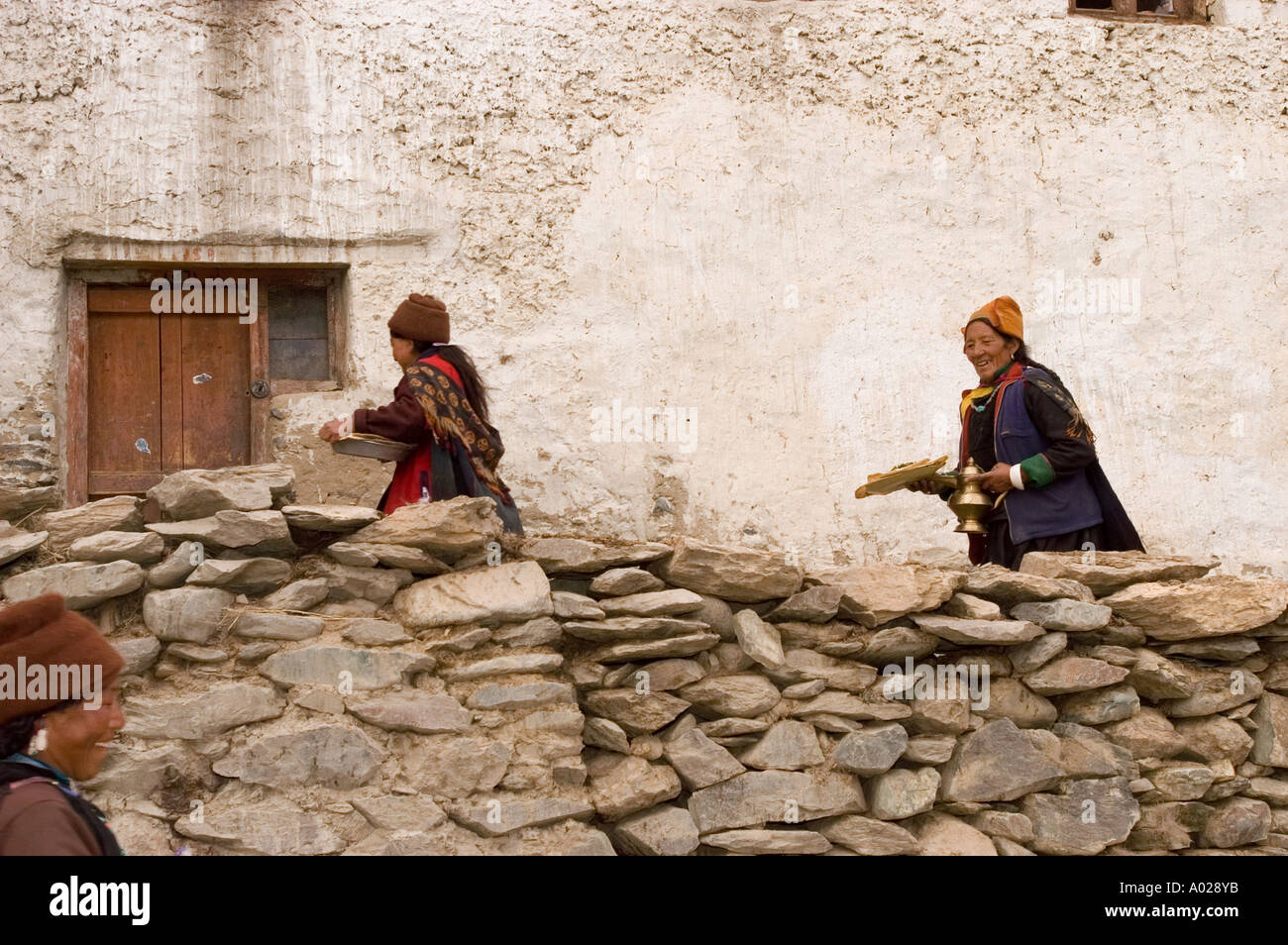 Old woman bringing food on Karsha rocky street Traditional Zanskari ...