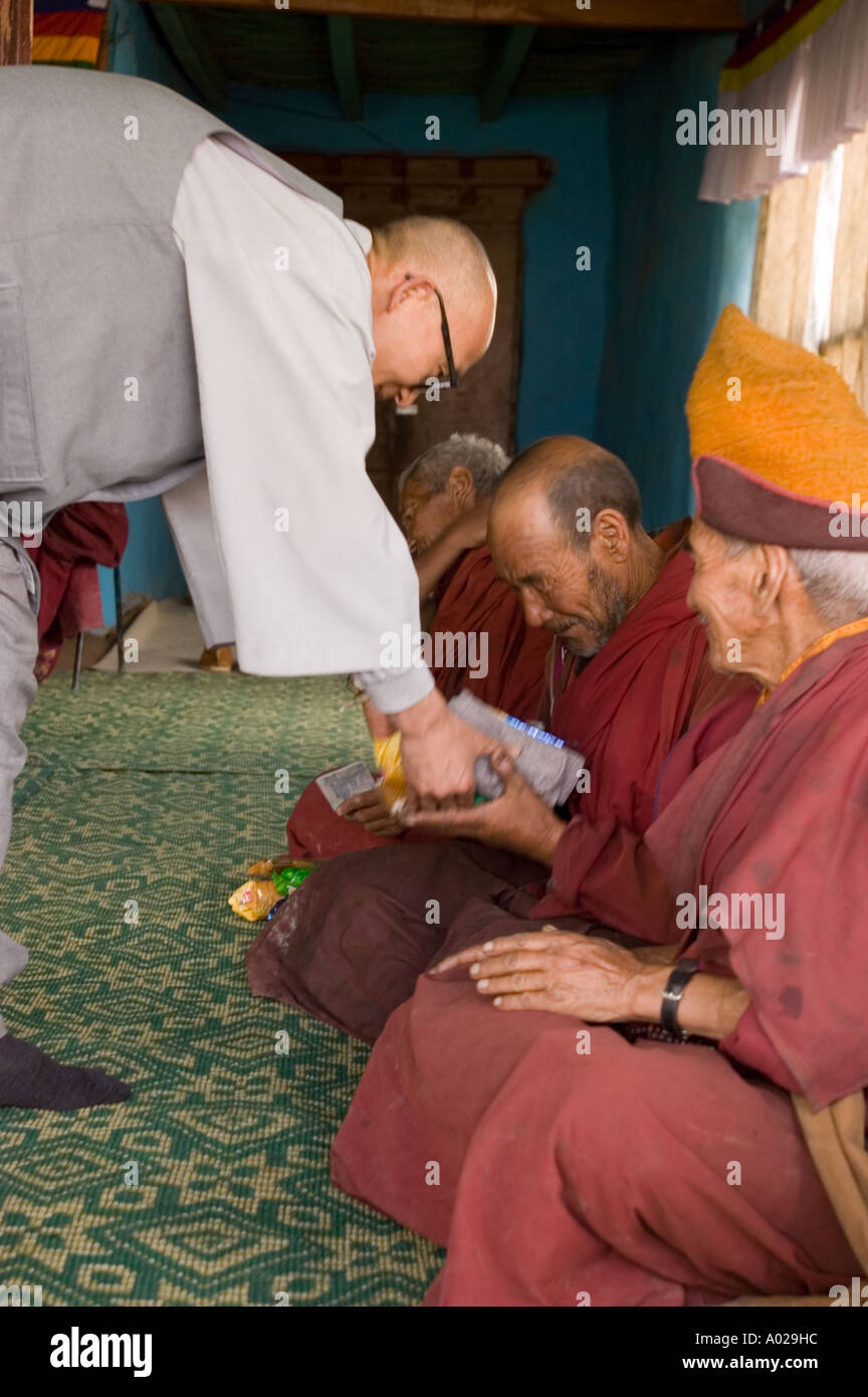 Korean monk giving gifts to Tibetan monks Karsha monastery Zanskar ...