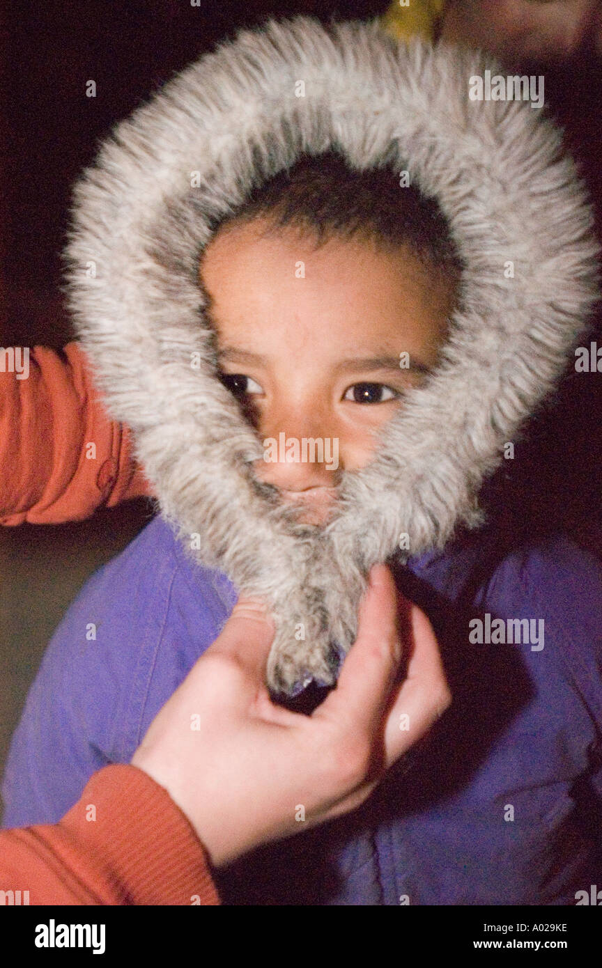 Adult hand holding eskimo like hood of asian child Stock Photo - Alamy