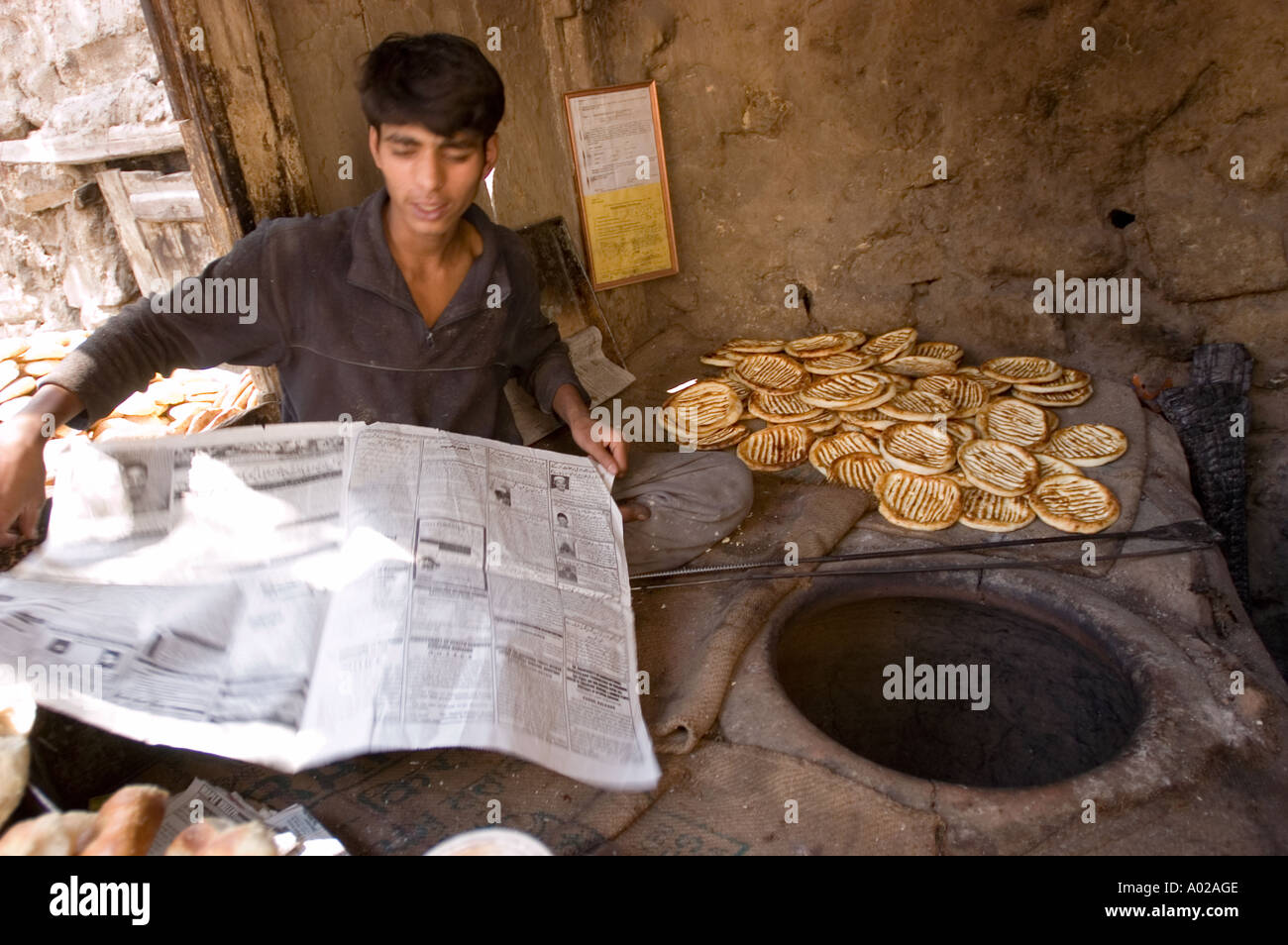 Muslim baker with traditional oven in old part of Leh Ladakh India ...