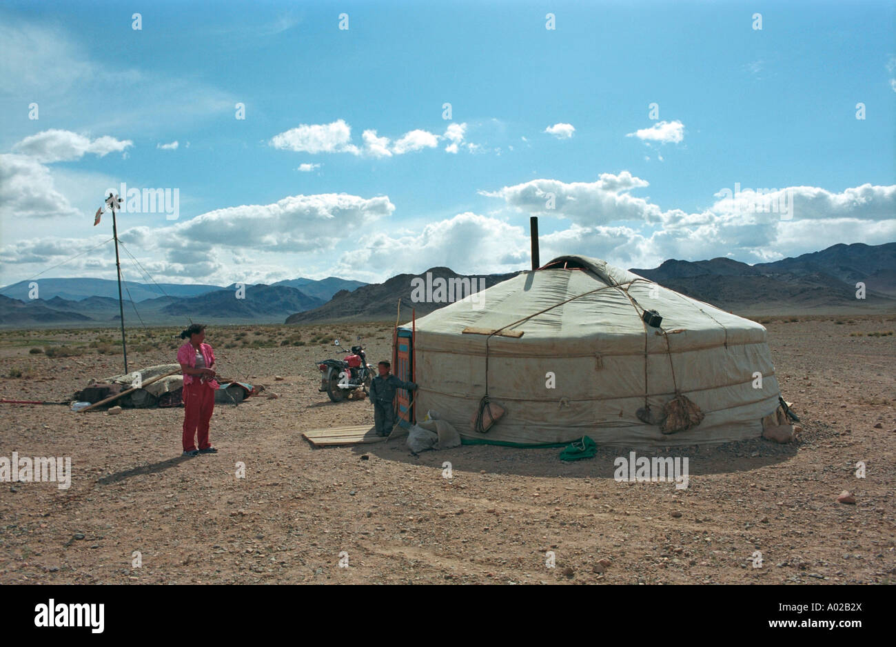 Woman and her son near traditional Mongolian dwelling yurt or ger ...