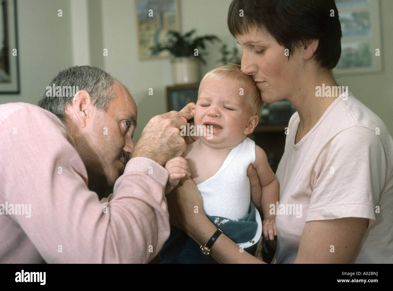 Doctor checking patient ears hi-res stock photography and images - Alamy