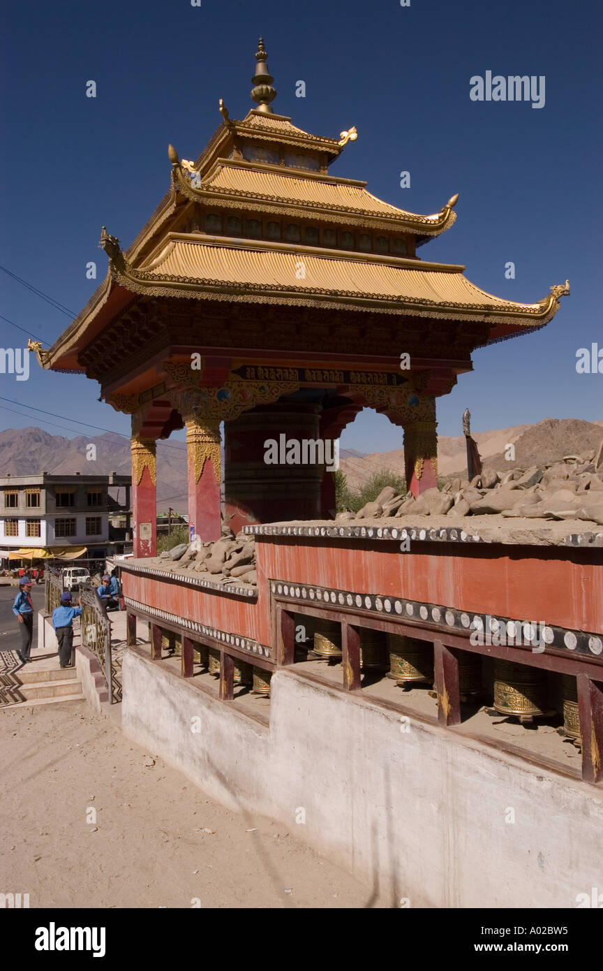 Traditional big prayer wheel and prayer wheel wall in Leh Ladakh India ...