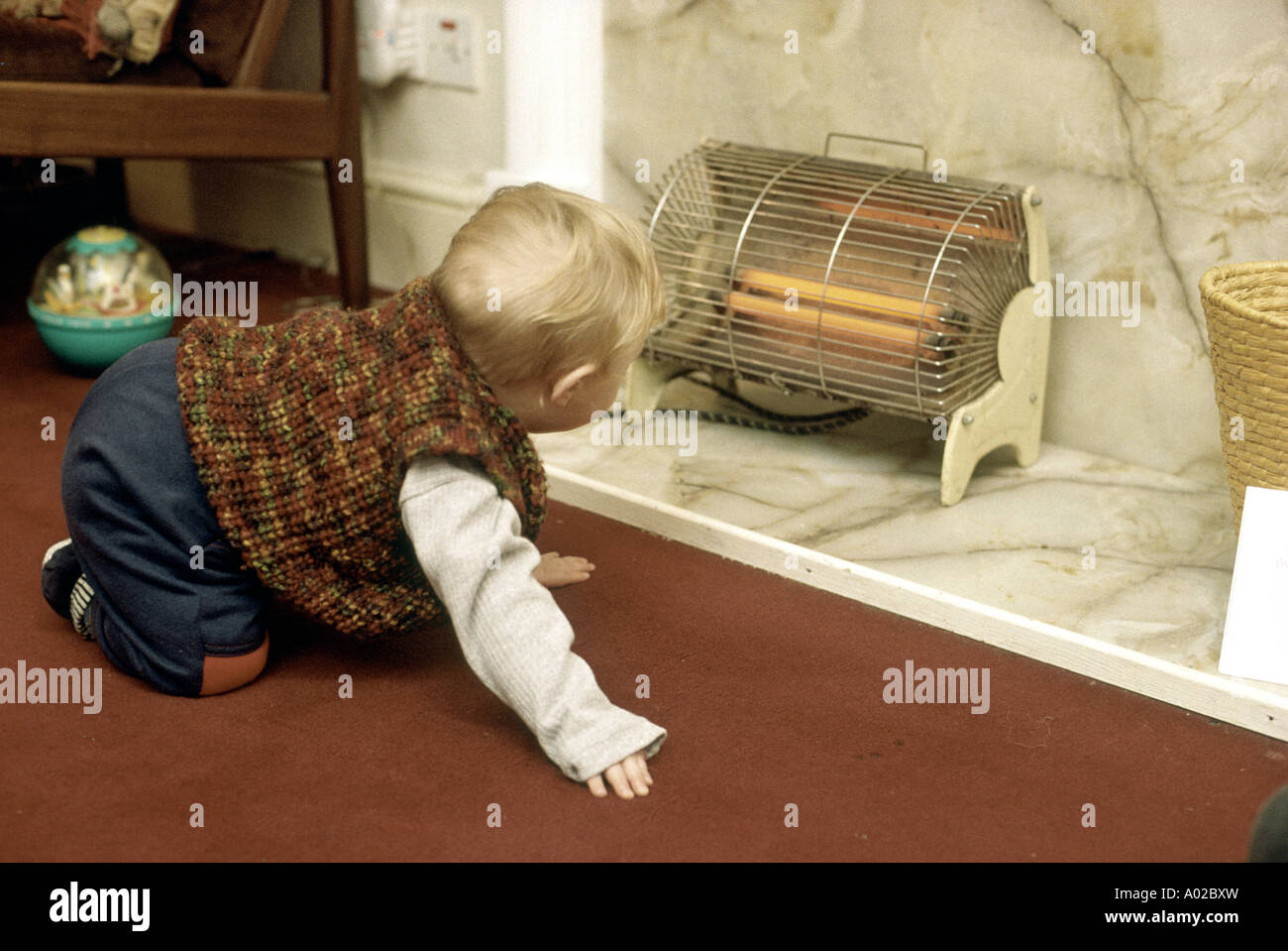 child crawling close to an electric fire Stock Photo - Alamy