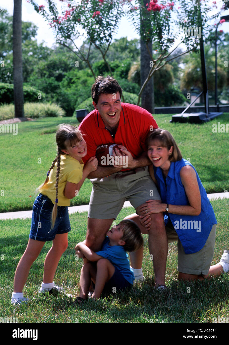 Family portrait playing football Stock Photo - Alamy