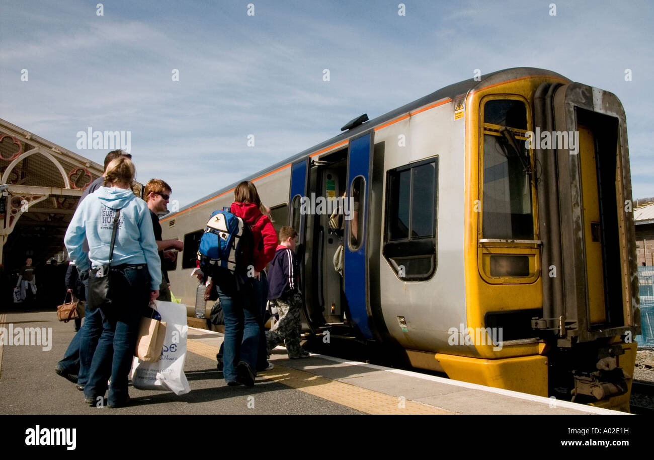 A group of passengers on the platform boarding the arriva train at ...