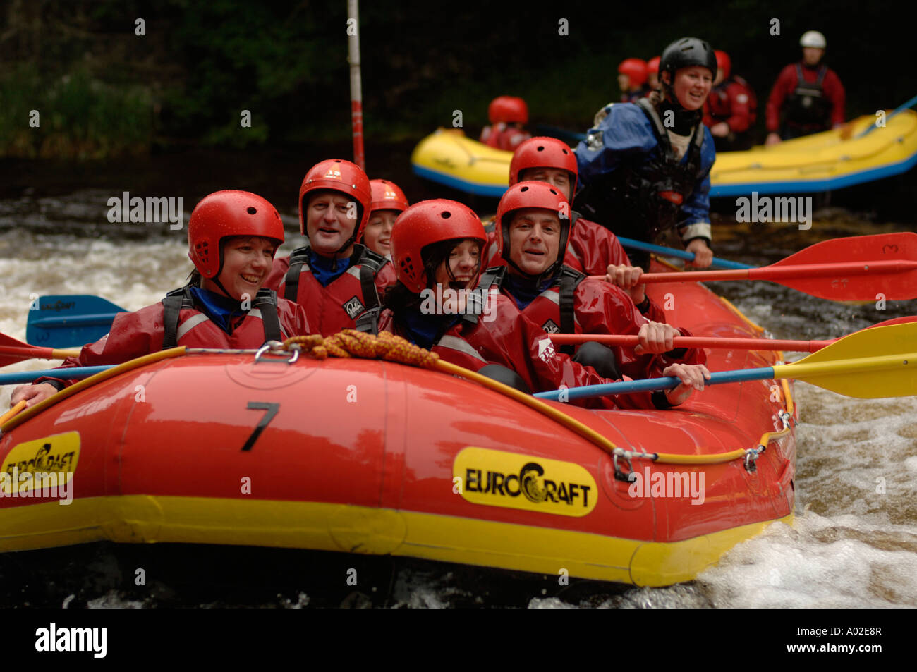 group of people on team building weekend white water rafting at the ...