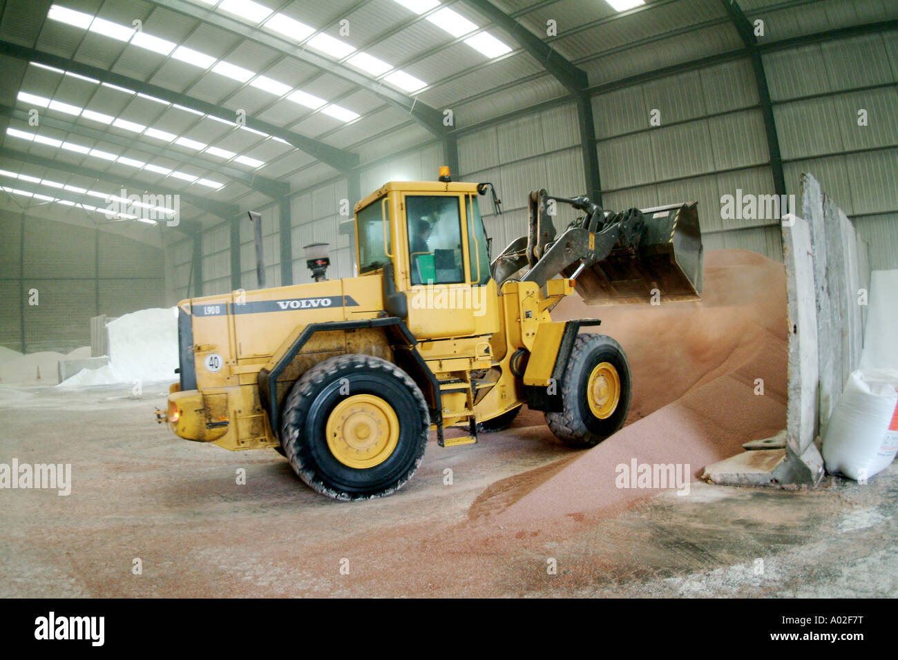 Yellow Volvo L90D wheel loader machine working in a fertilizer factory ...