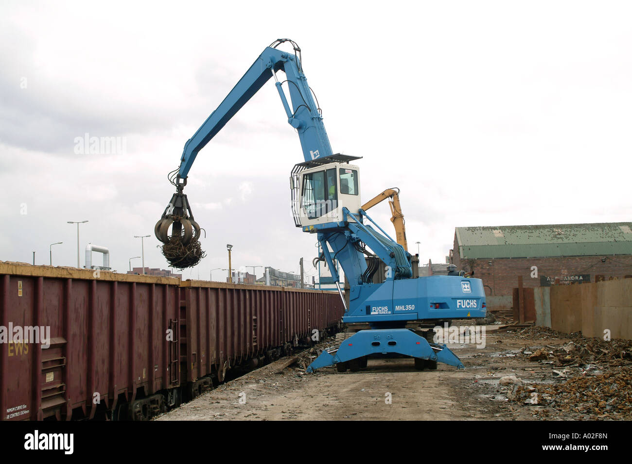 Fuchs MHL 350 loader unloading scrap metal from a train in the uk Stock ...