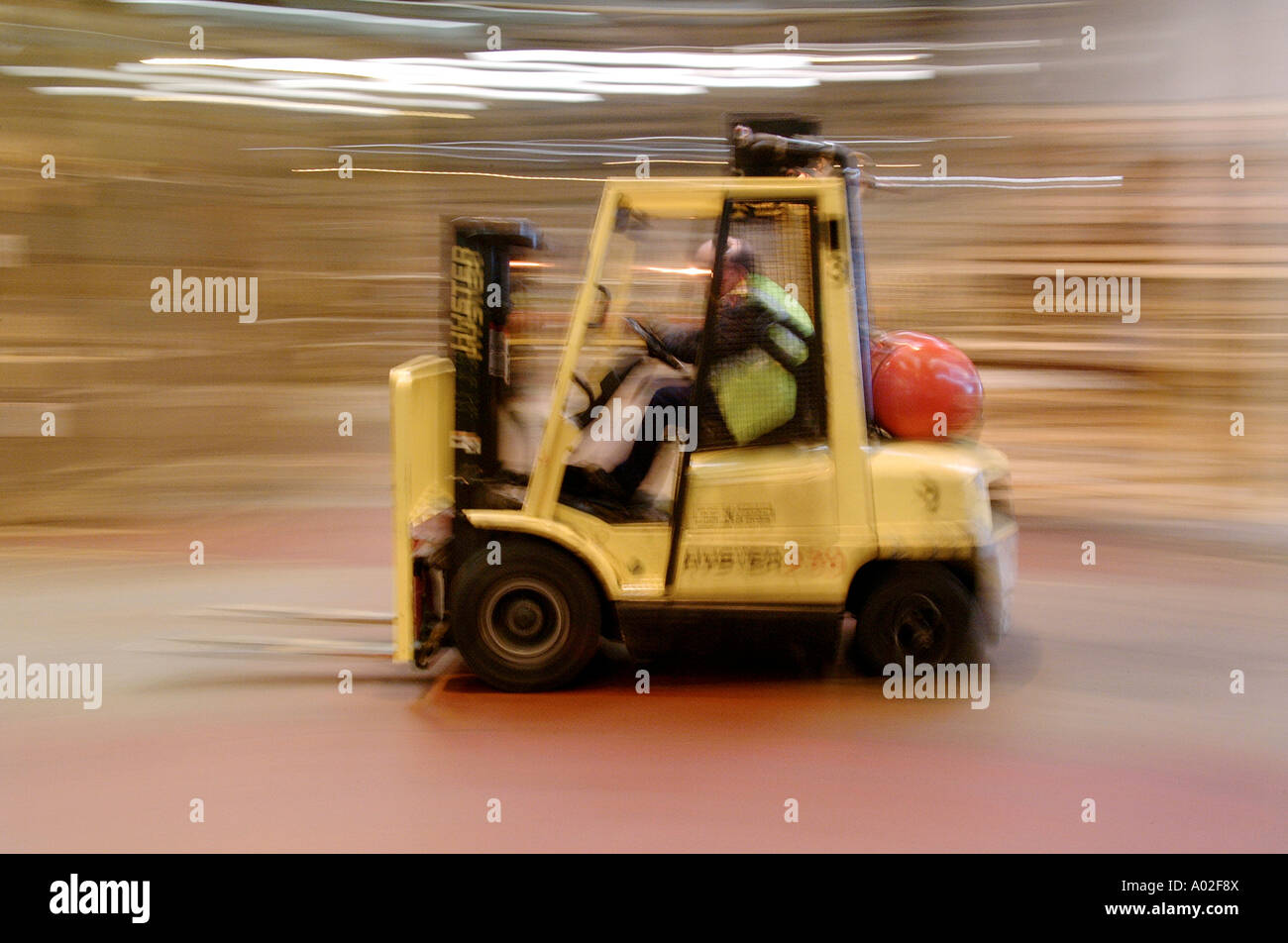 Forklift truck speeding through a factory in the uk Stock Photo ...