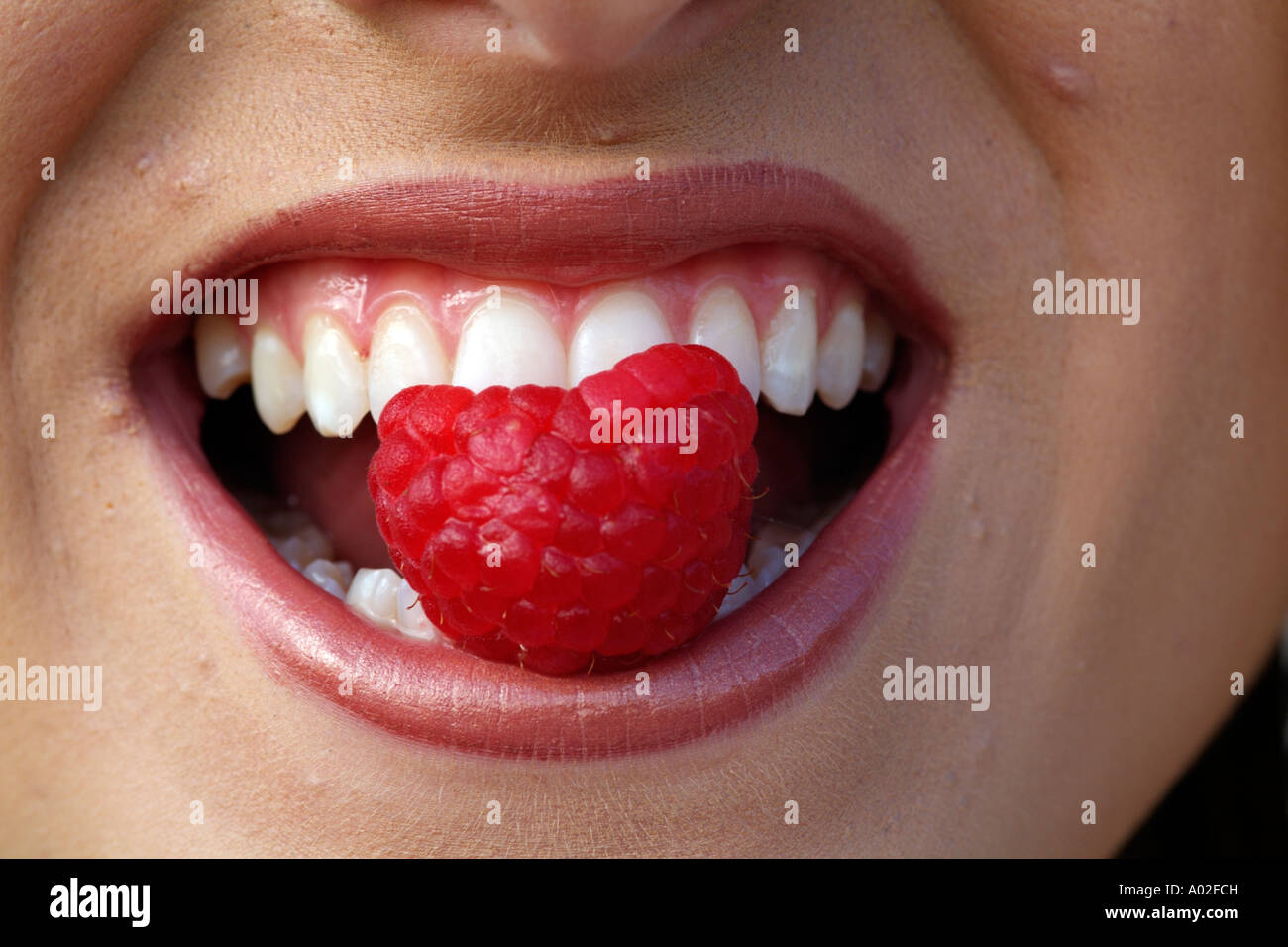 teenager enjoying a raspberry Healthy eating Stock Photo - Alamy