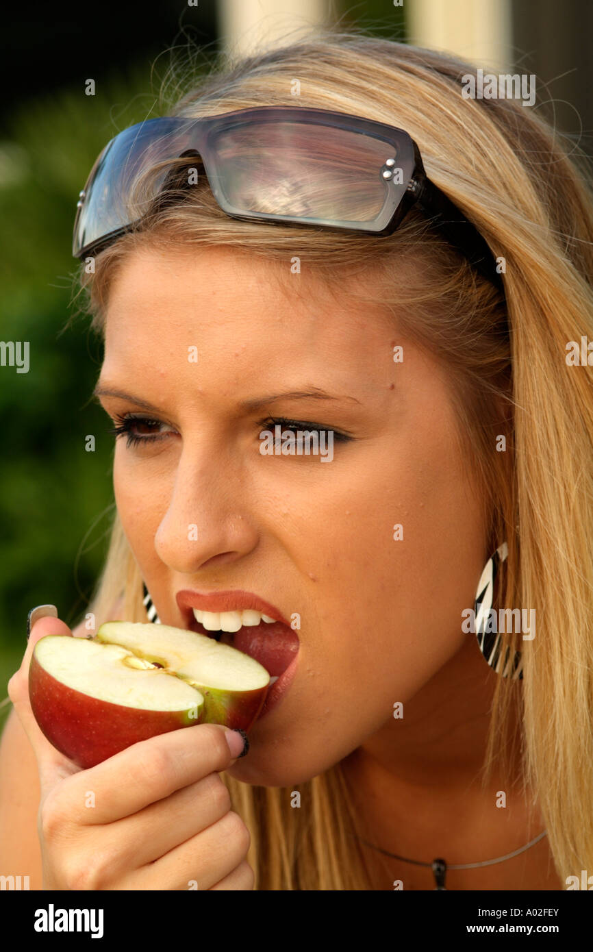 Head shot of an attractive girl eating an apple Healthy eating Stock ...