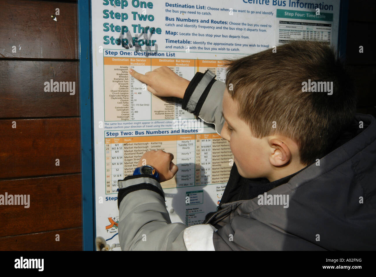 young boy checking the timetable at a bus stop in the uk Stock Photo ...