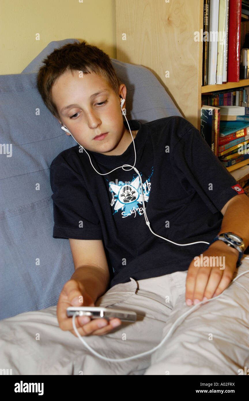 young boy listening to his ipod at home Stock Photo - Alamy