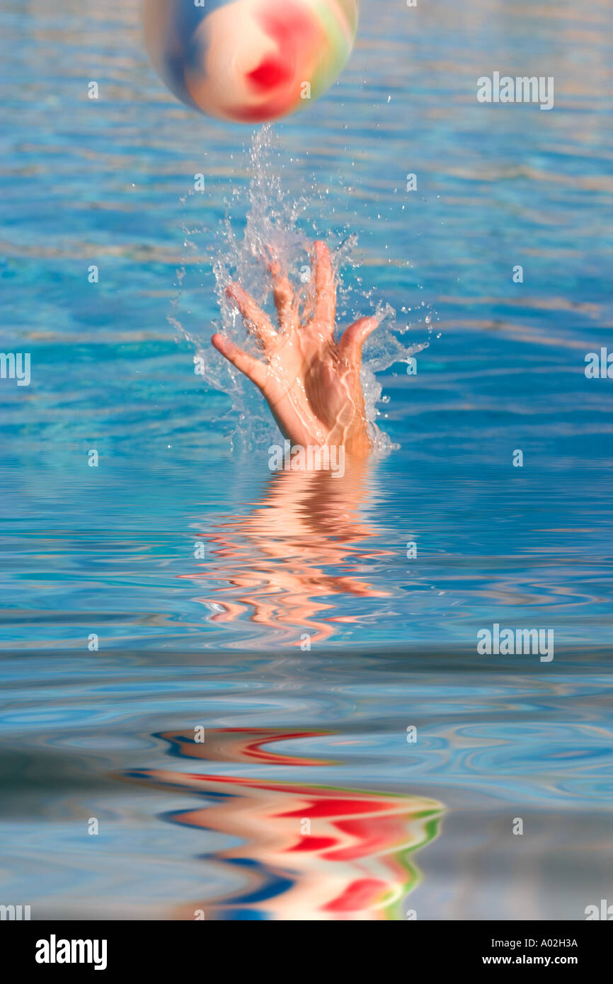 Hand Reaching for Ball from Swimming Pool Stock Photo - Alamy