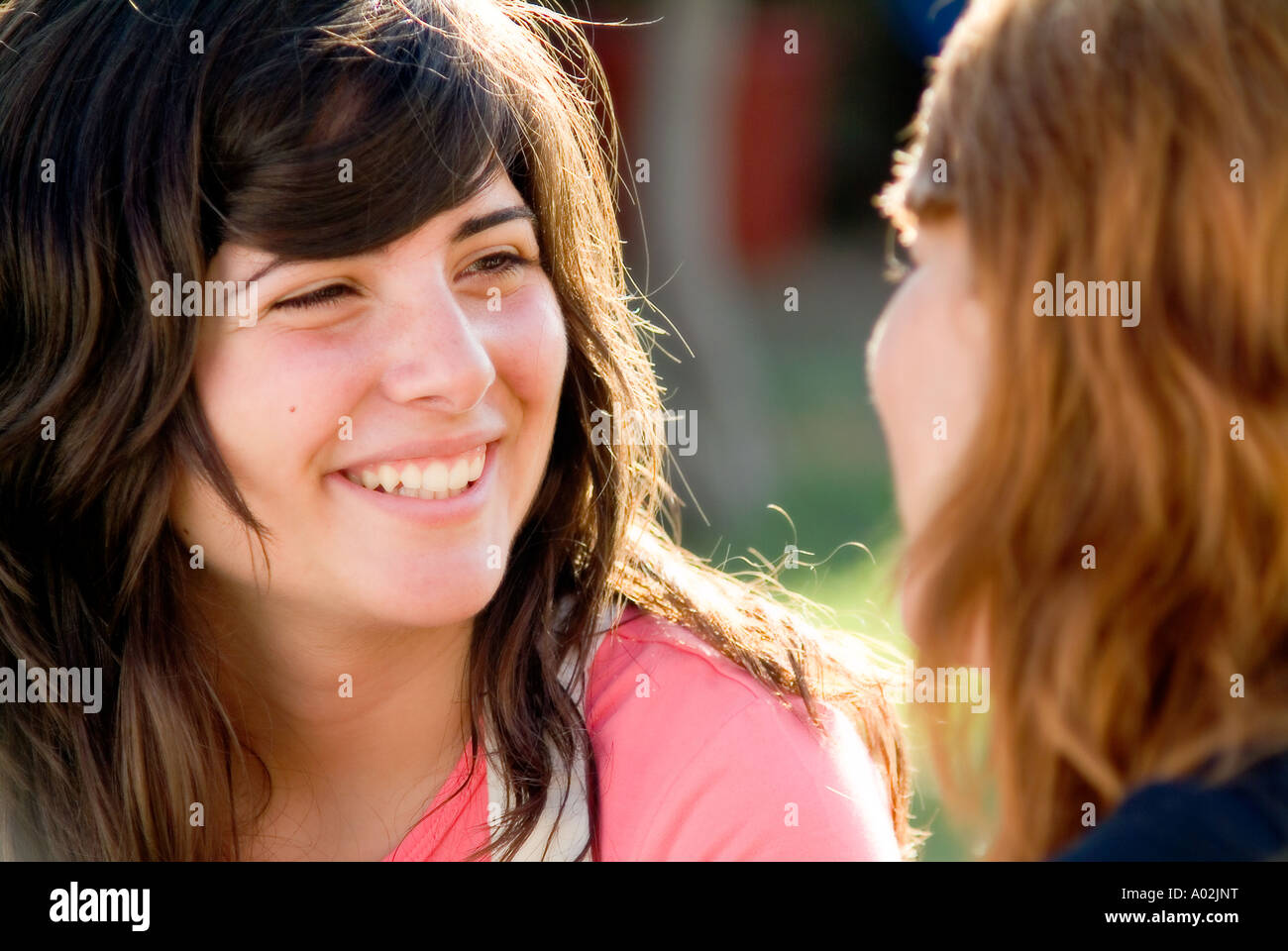 Two girls talking each other Stock Photo - Alamy