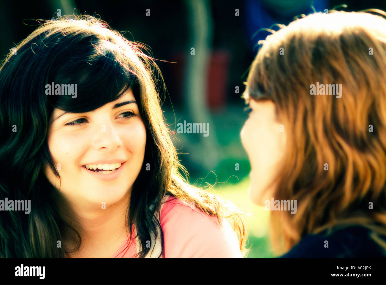 Two girls talking each other Stock Photo - Alamy