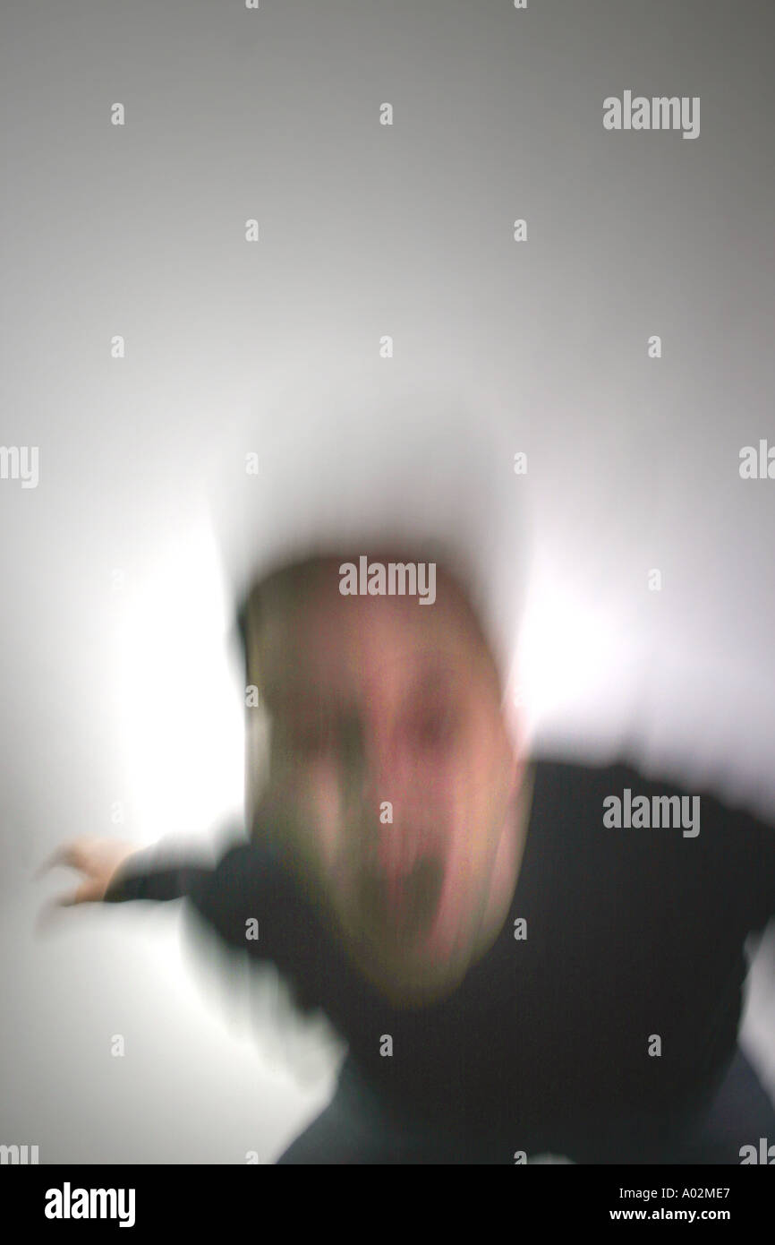 Haunting horror image of blurred mans face coming fast at the camera ...