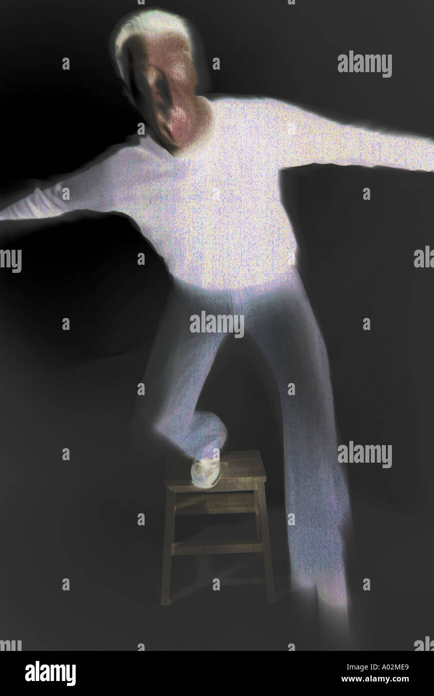 Man stood on stool losing his balance and about to fall over with ...