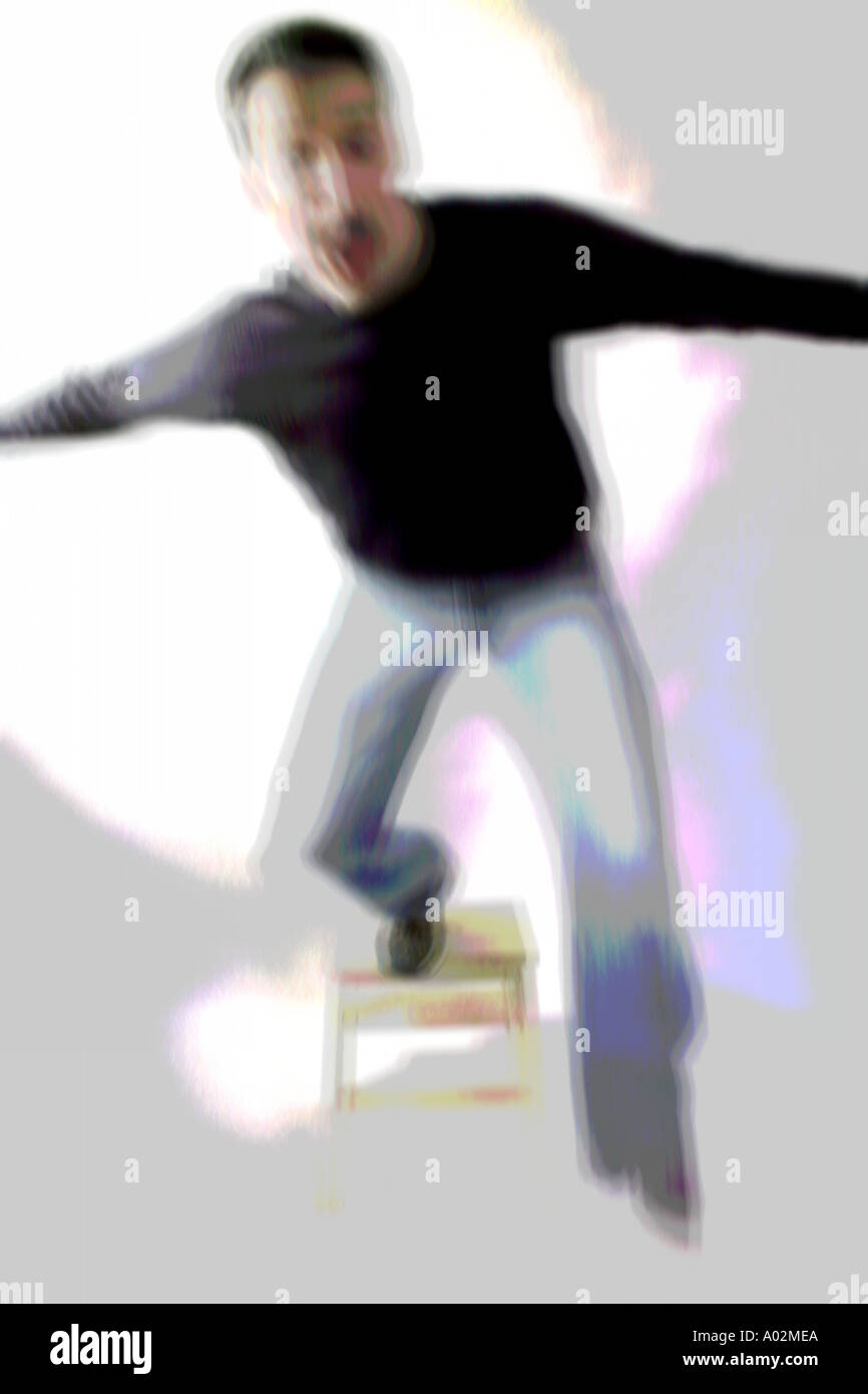 Man stood on stool losing his balance and about to fall over with ...