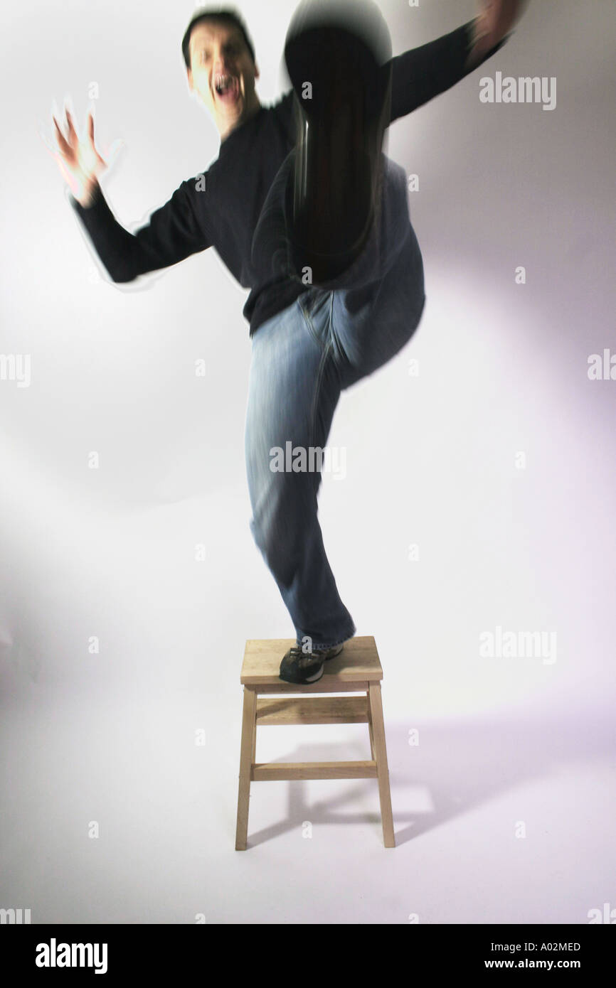 Man stood on stool losing his balance and about to fall over Stock ...