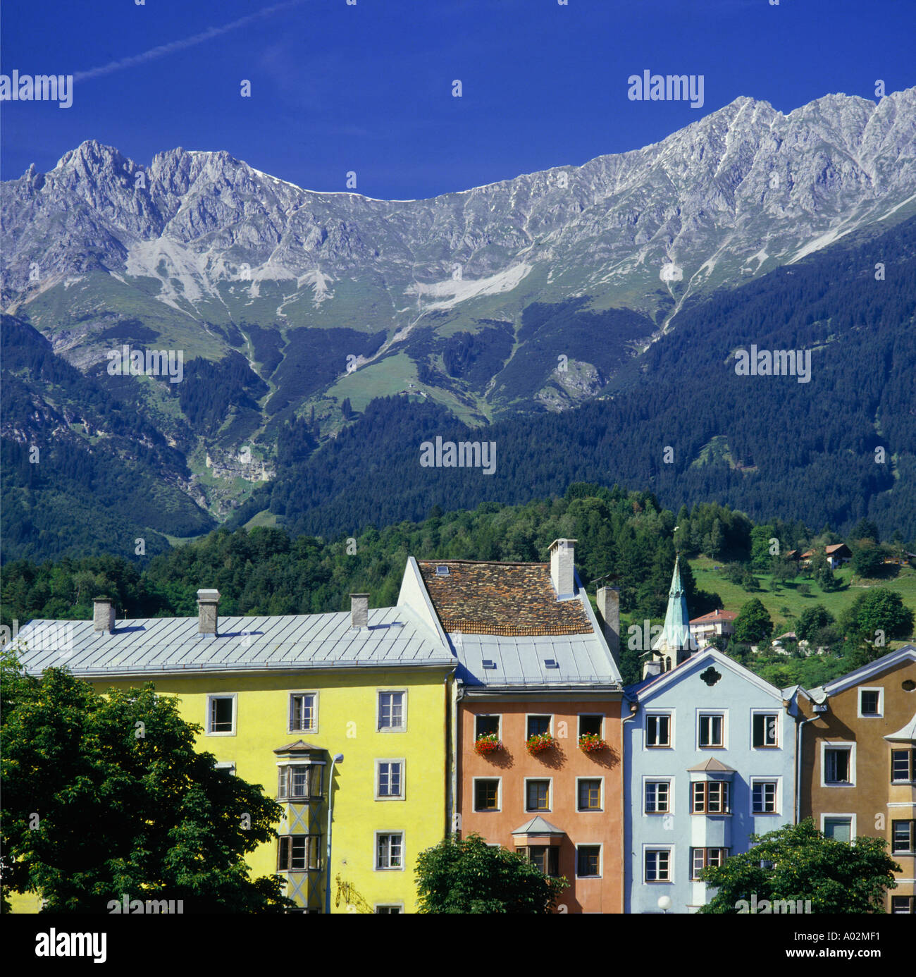 Summer view of a row of pretty coloured buildings & blue sky with ...