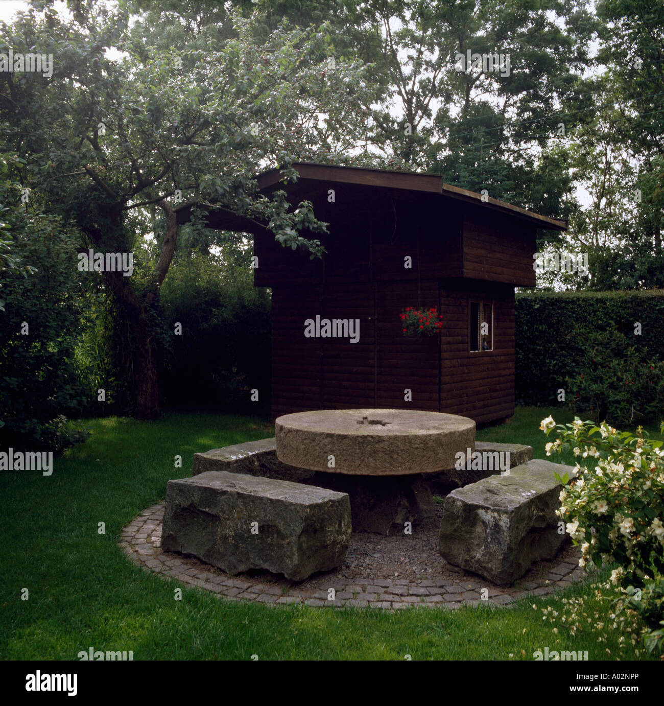 Circular millstone table and block benchs on small circular patio ...