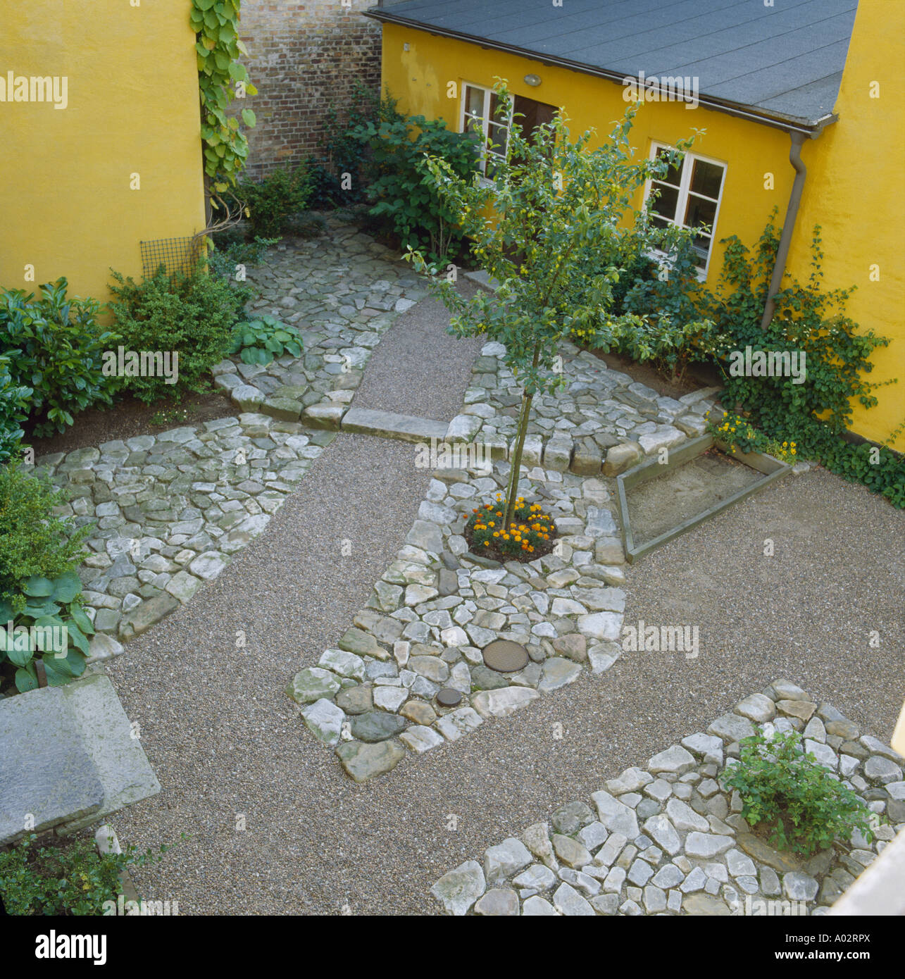 Aerial view of courtyard gravel paths and small trees planted in paved ...
