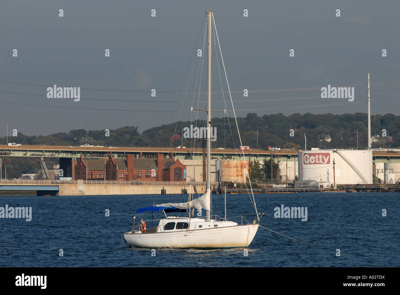 Sailboat moored in a busy oil port in New Haven Connecticut USA with ...