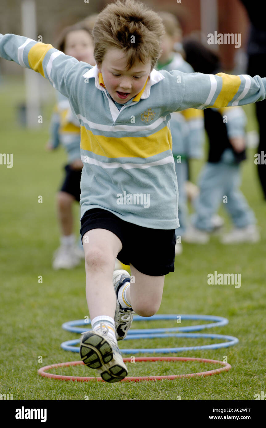 School boy completing hoop jumps Stock Photo - Alamy
