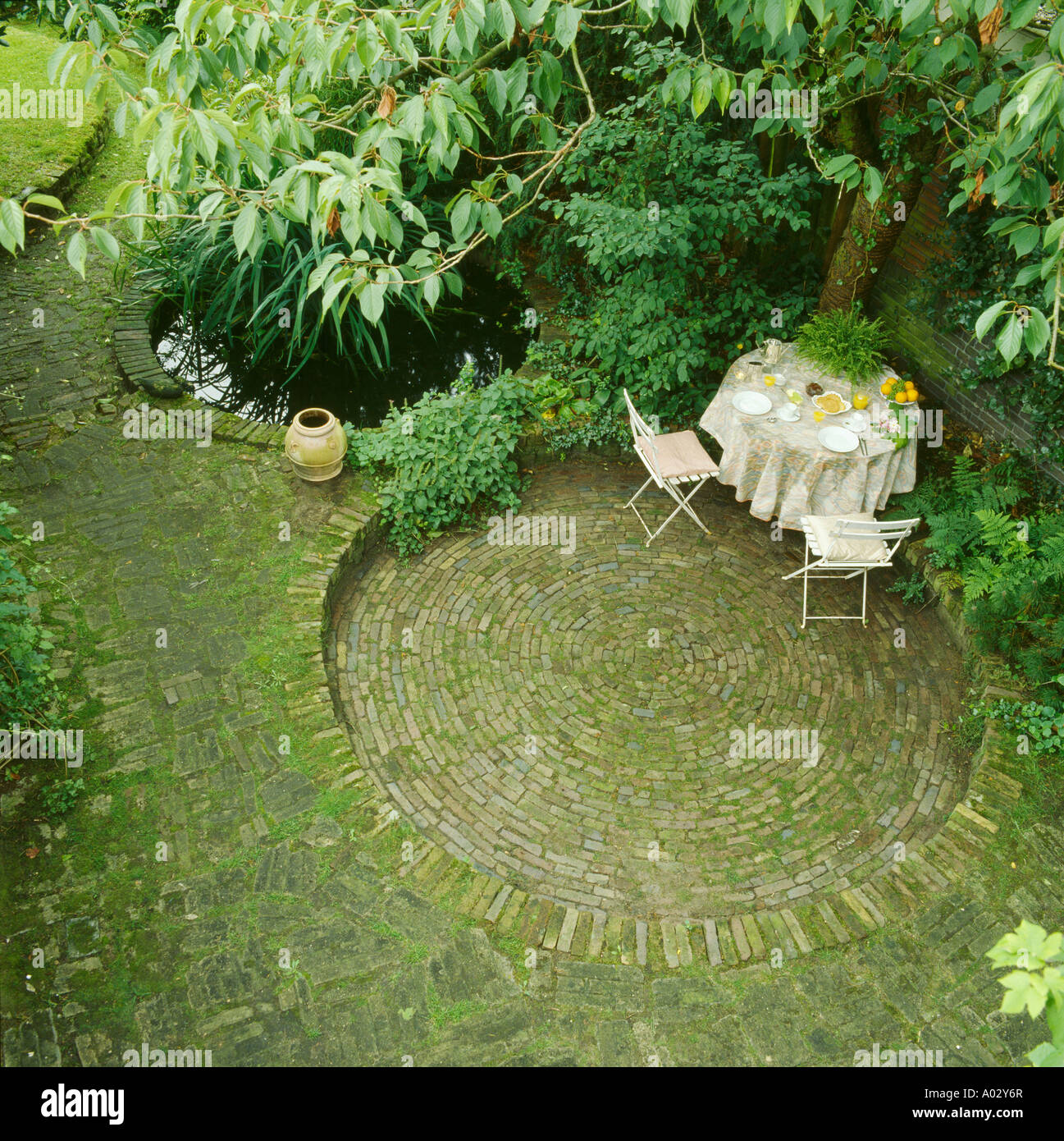 Aerial view of circular paved patio with furniture in town garden Stock ...
