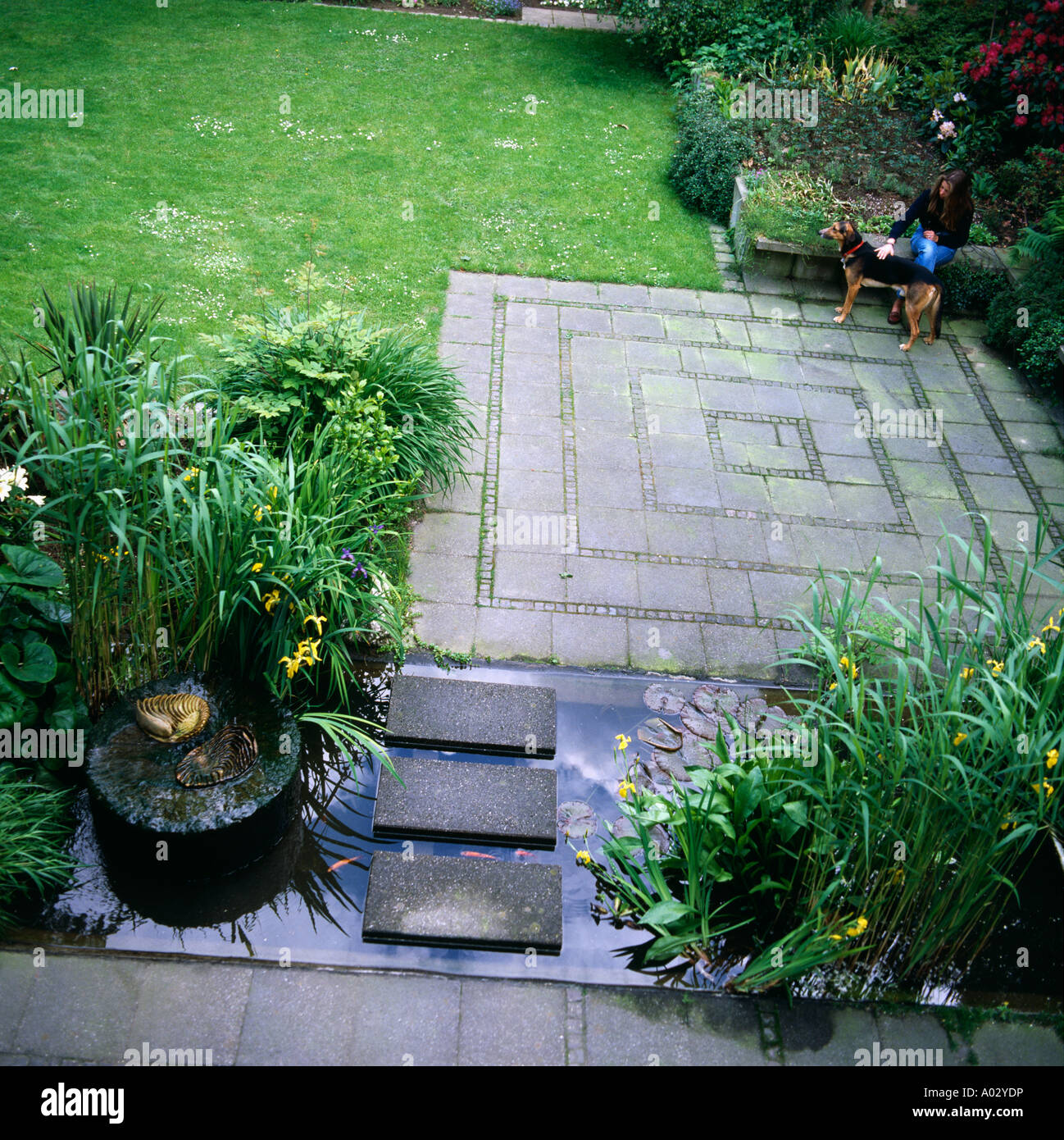 Paving stones over garden pond with square paved terrace Stock Photo ...