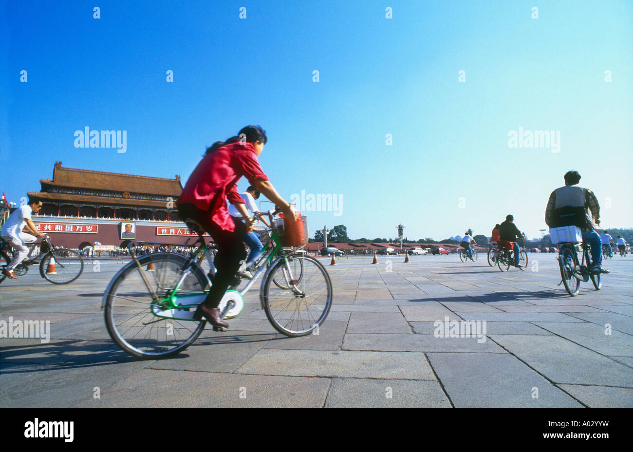 Early morning rush hour at Tiananmen Square young woman in red jacket ...