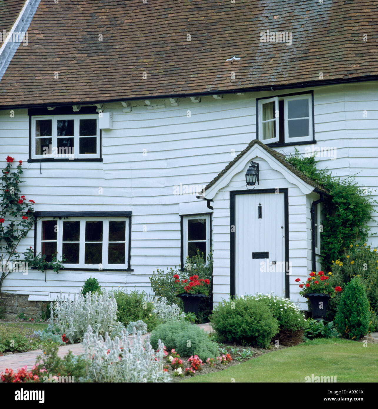 Traditional white-painted wooden cottage in country Stock Photo - Alamy