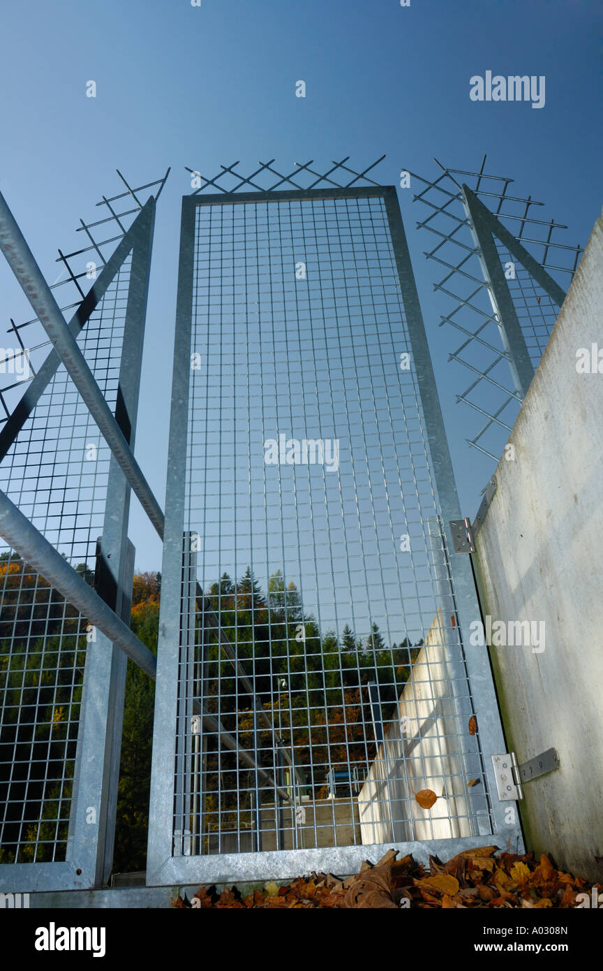 An iron gate with sharp wires across the top to stop people climbing ...