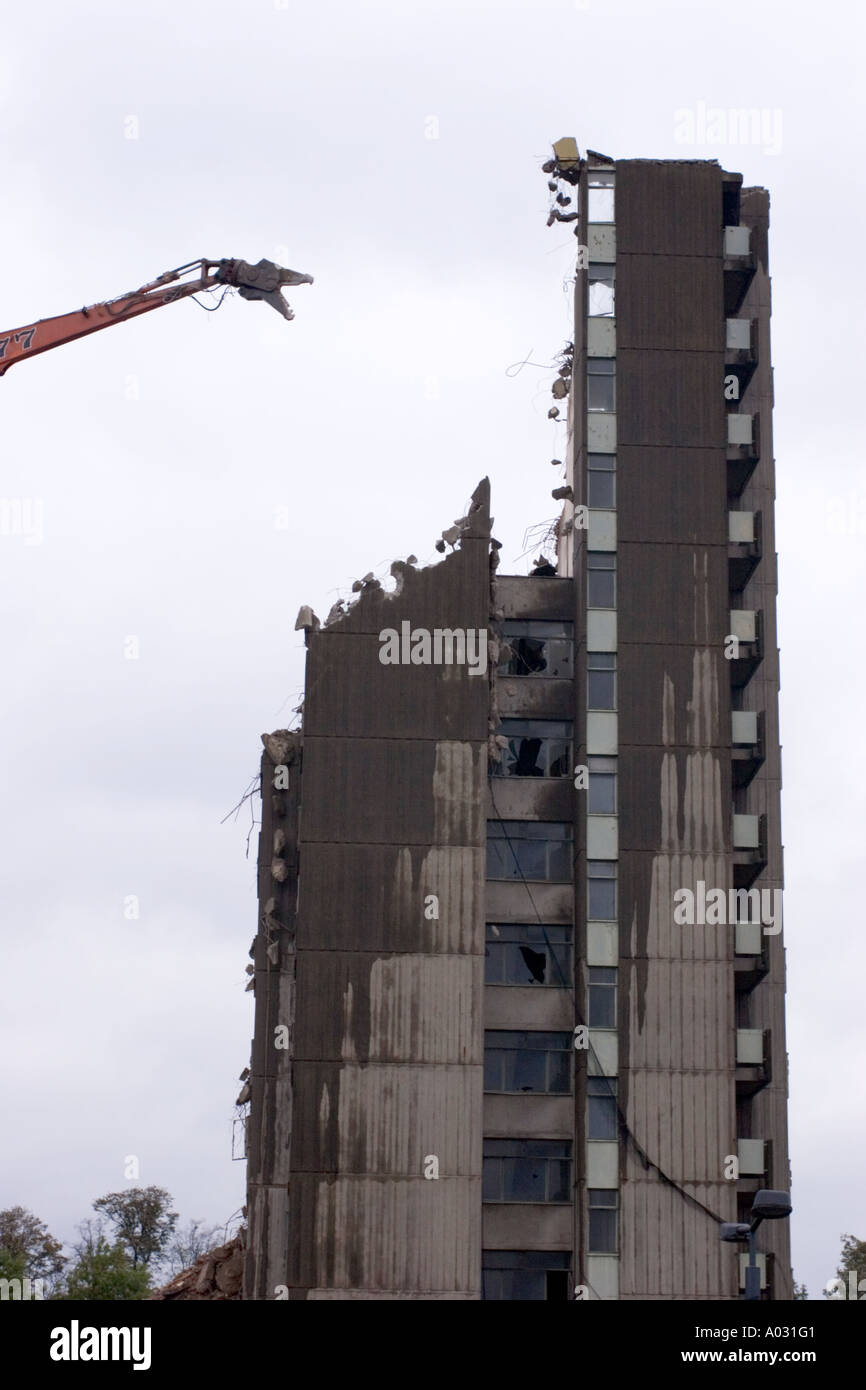 Demolition of tower block in Woodford Essex using crane with boom and ...
