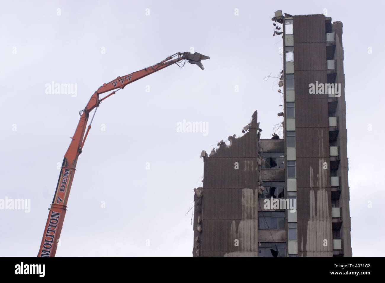 Demolition of tower block in Woodford Essex using crane with boom and ...
