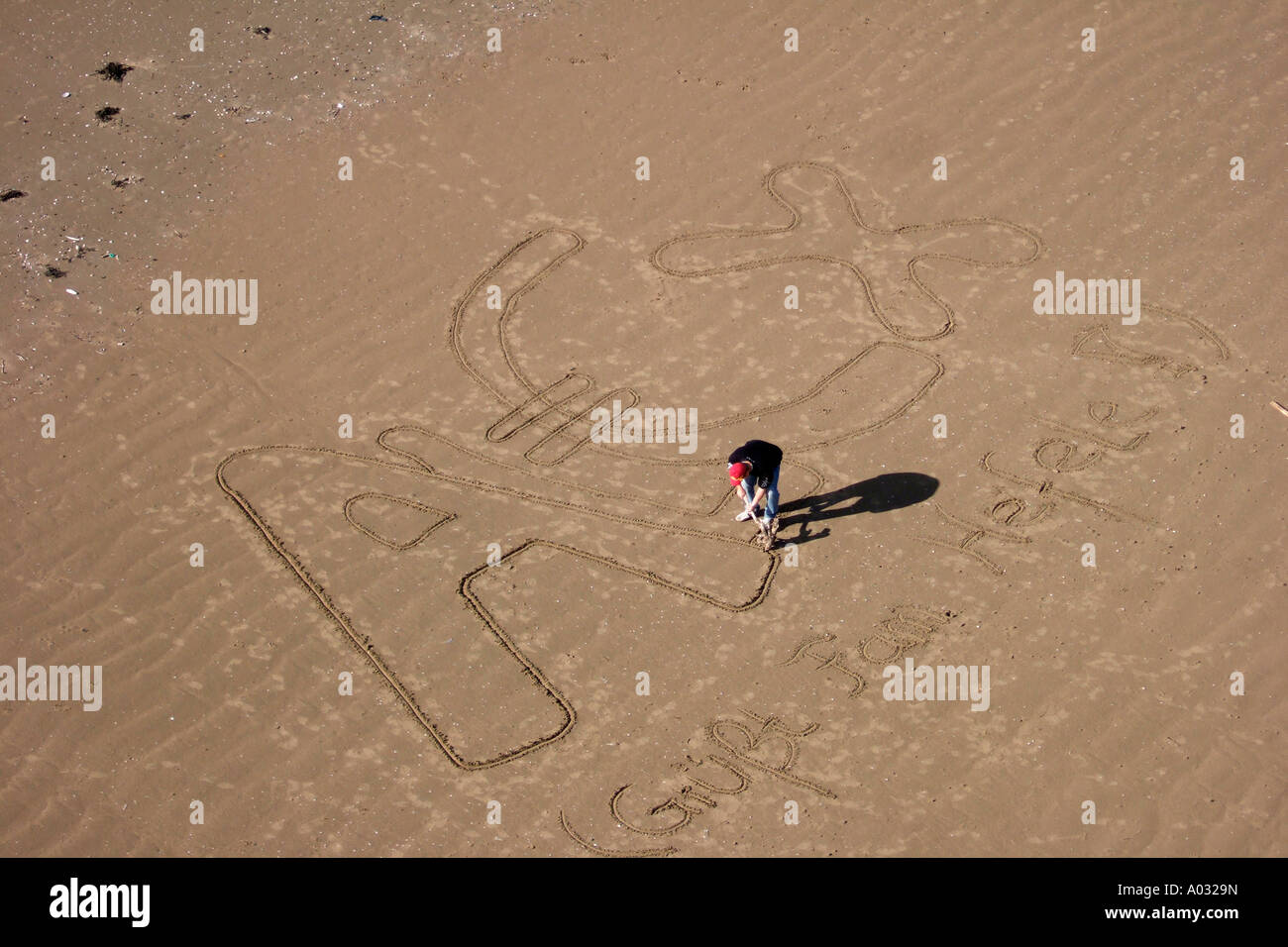 german youth writing his name in the sand on a beach Stock Photo - Alamy
