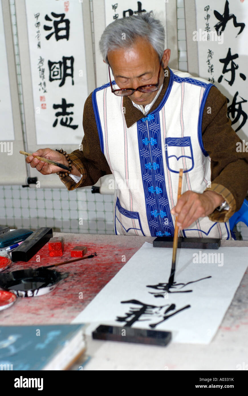 Calligraphy master uses both hands for his artwork Yunnan China Stock ...
