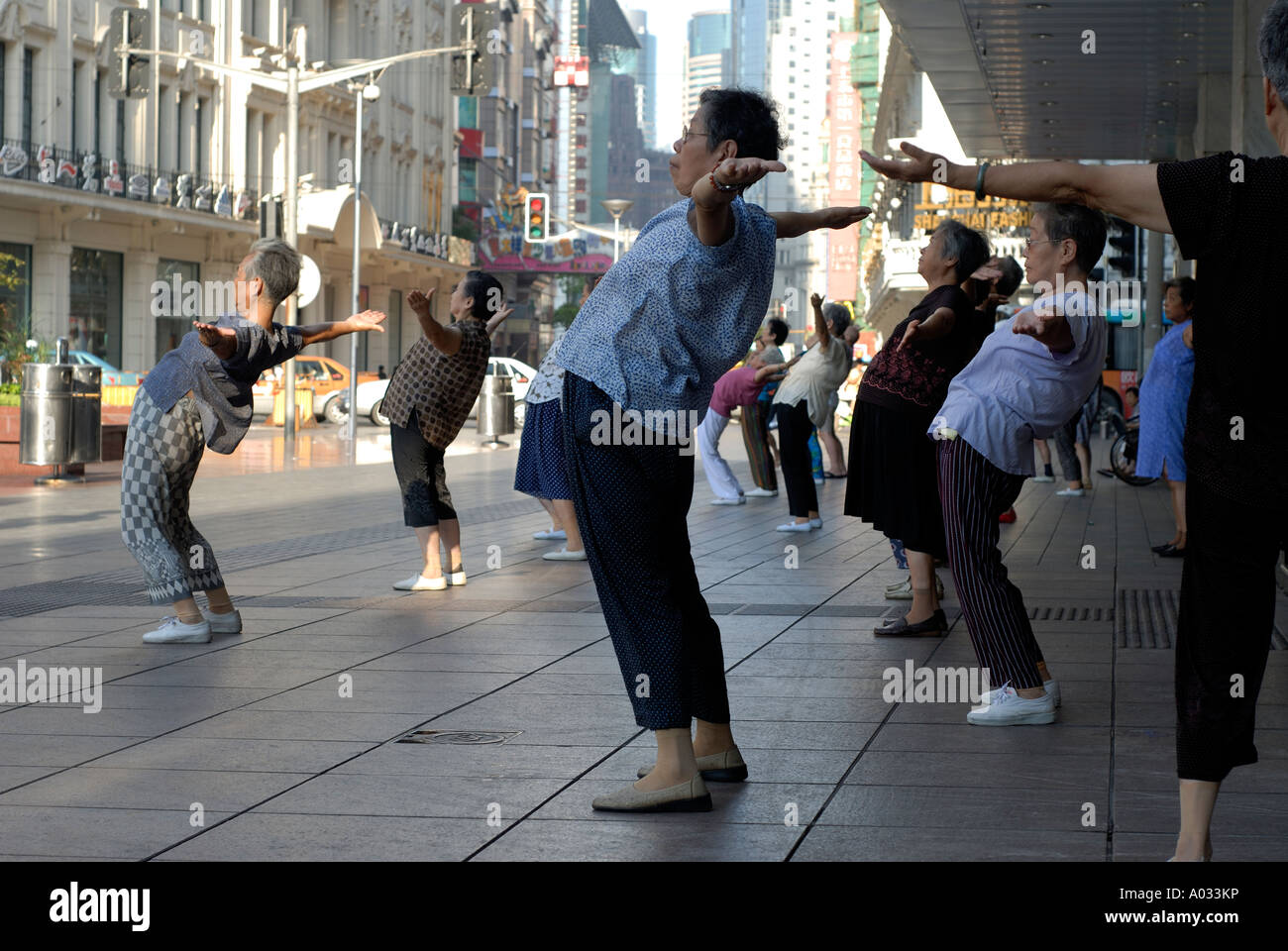 Elderly Chinese women doing morning exercise in the streets of Shanghai ...