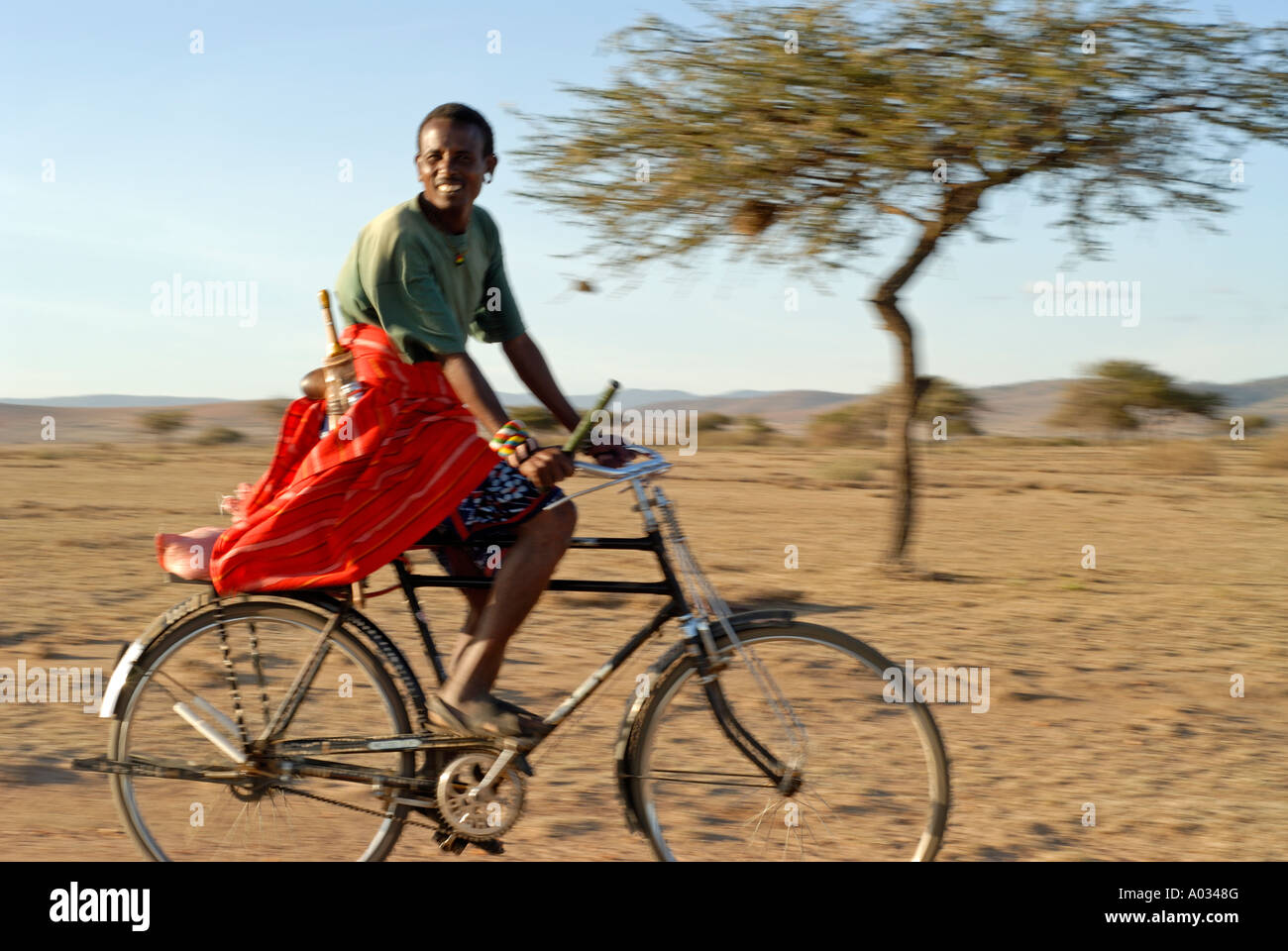 Samburu warrior riding bicycle in the plains of Northern Kenya Stock ...