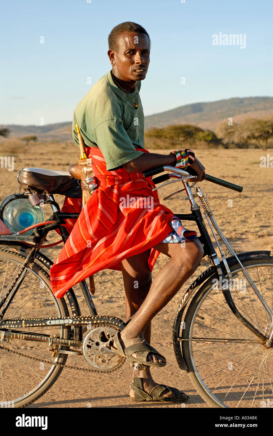 Samburu warrior riding bicycle in the plains of Northern Kenya Stock ...