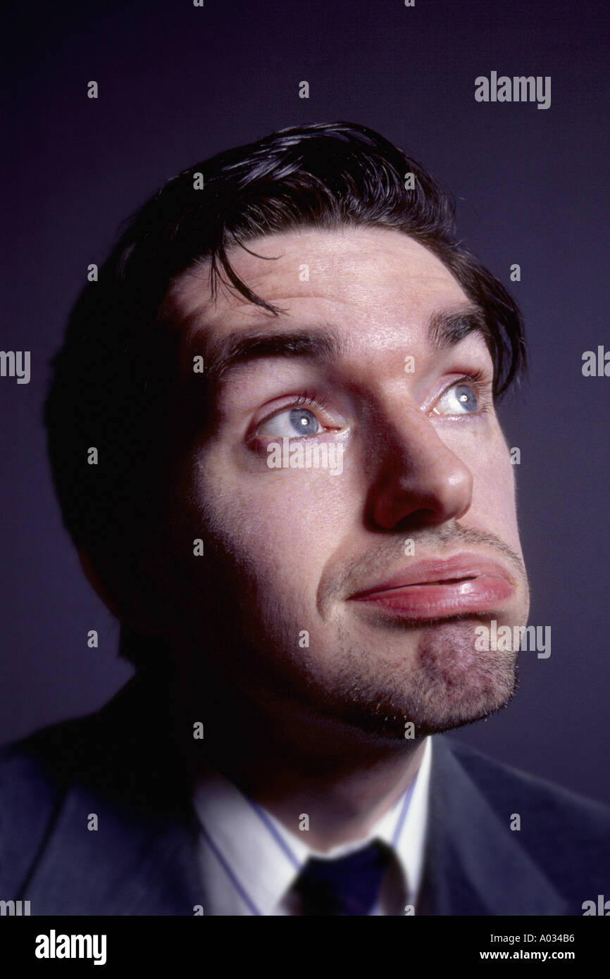 Man in suit sighing Stock Photo - Alamy