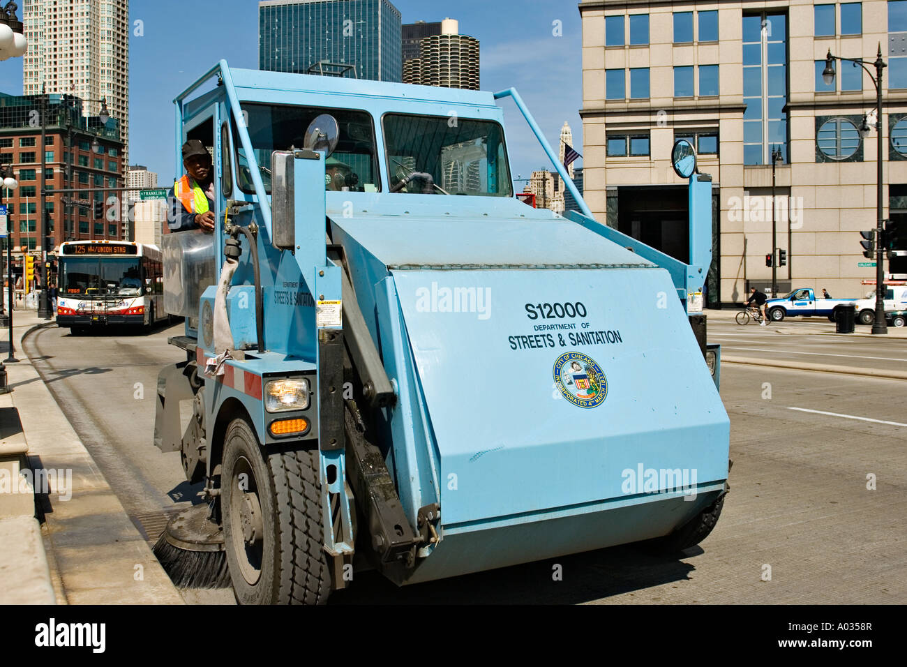 ILLINOIS Chicago Blue streetsweeper on Wacker Drive driver lean out ...