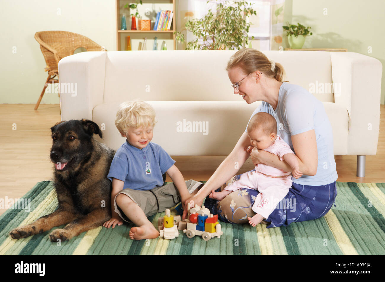 half breed dog with woman and two children Stock Photo - Alamy