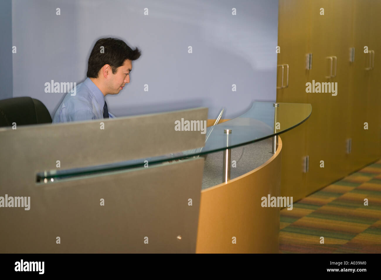 Asian male reception desk hi-res stock photography and images - Alamy