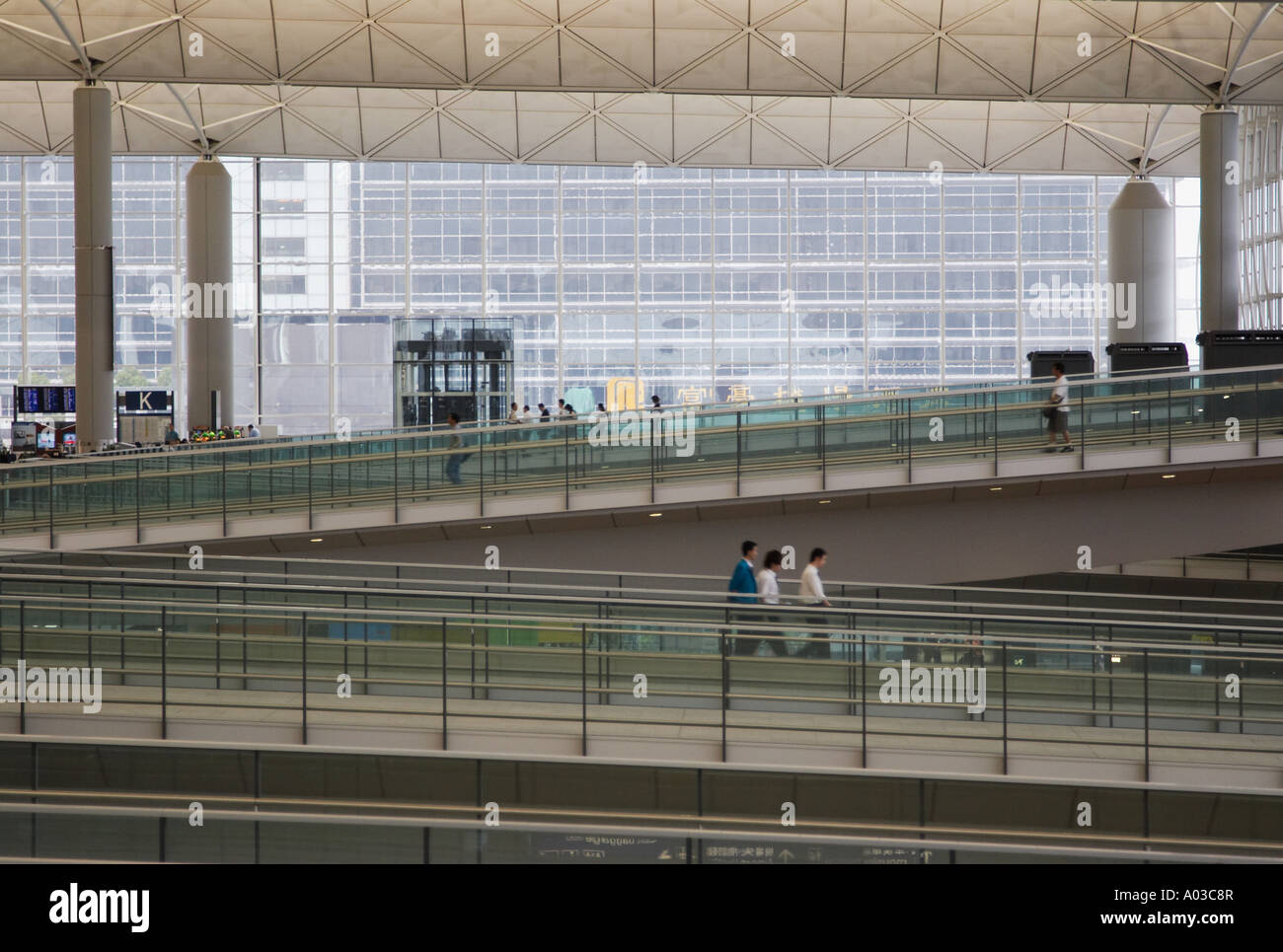 Passengers Walking Along Ramps At Hong Kong International Airport Stock ...
