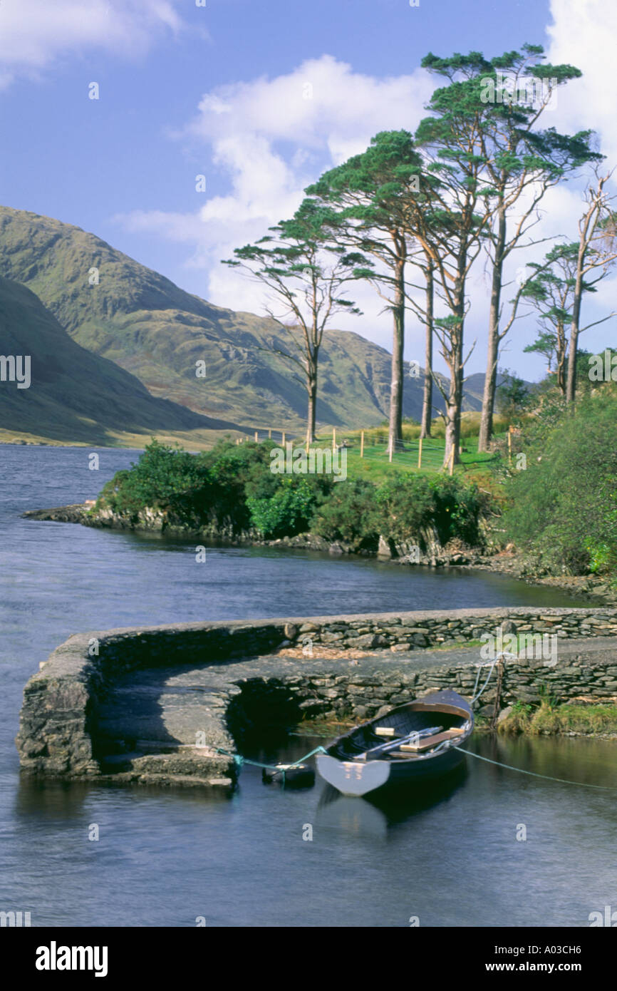 Small Harbor with boat, with background of trees mountains and lake ...