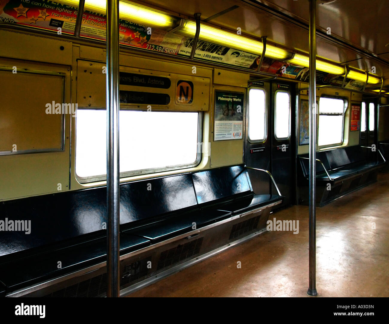 Interior of an empty New York City subway N-train with light streaming ...