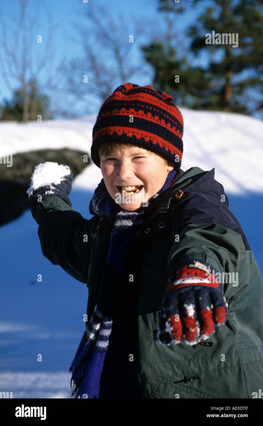 Model released boy throwing snowball in winter Stock Photo - Alamy